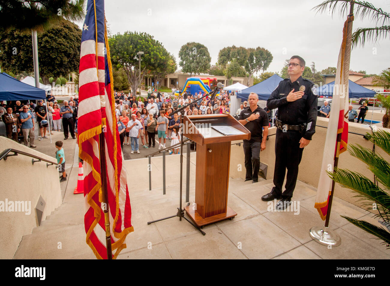 The Pledge of Allegiance is recited at a police department community ...