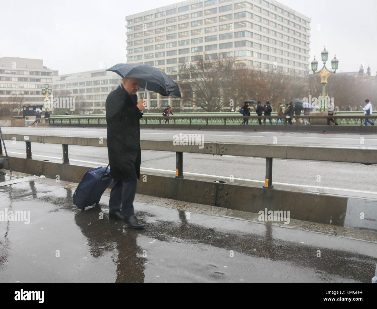 London UK. 7th December 2017. Pedestrians on Westminster are caught in ...