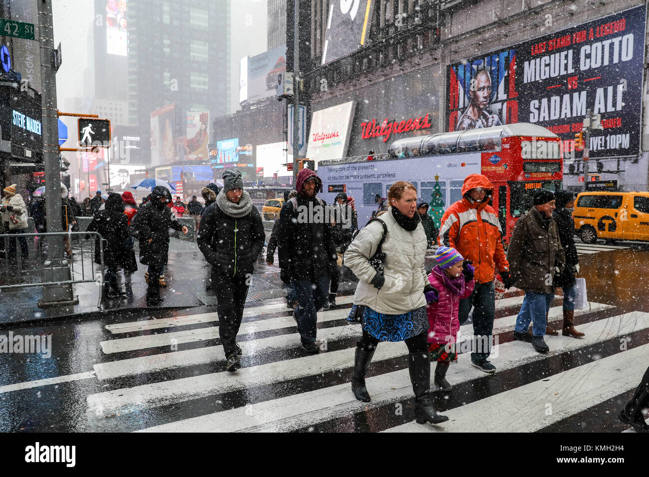New York, USA. 9th December, 2017. People take advantage of snow in Times Square during snowfall ...