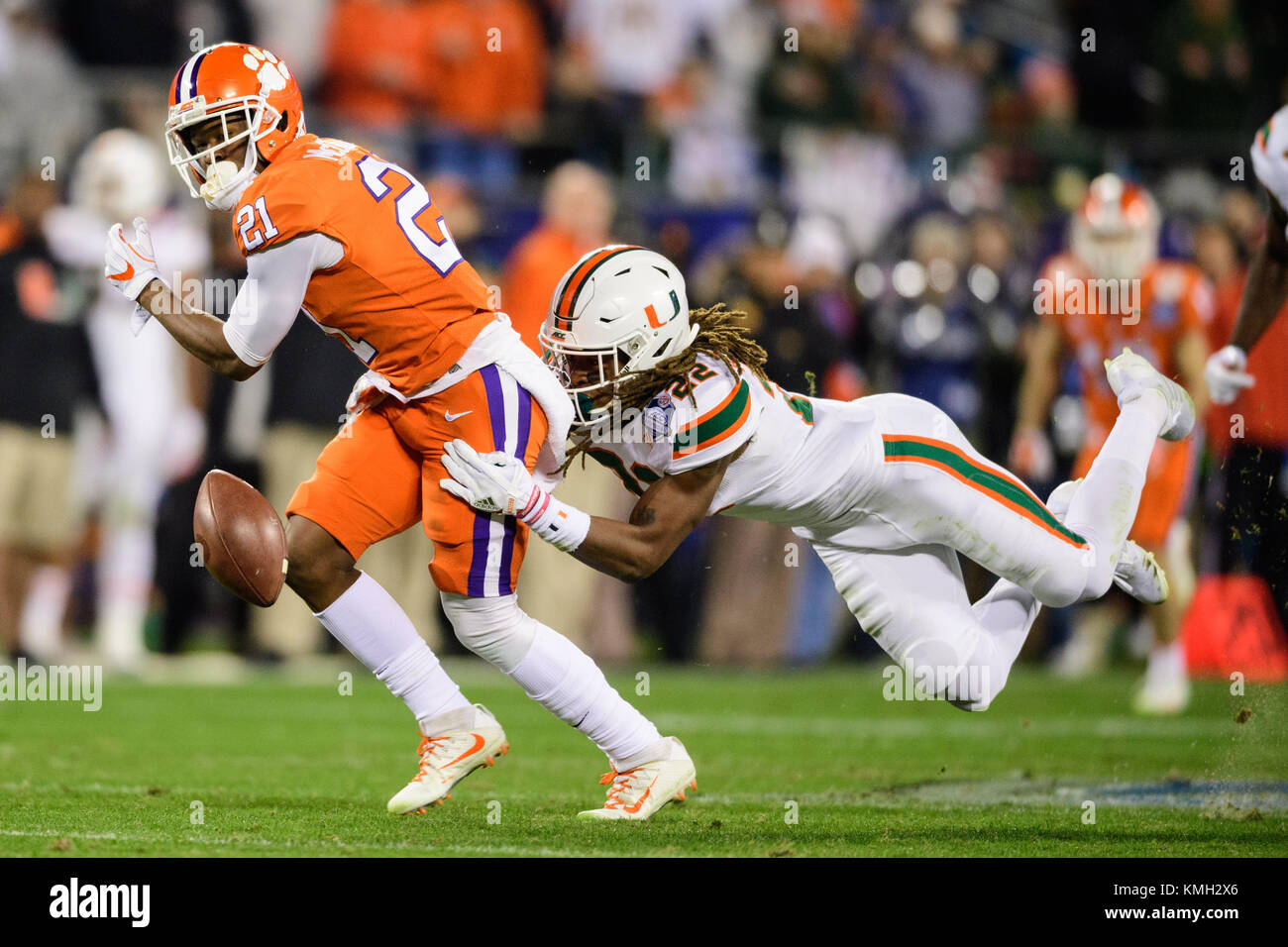Miami defensive back Sheldrick Redwine (22) forces a fumble from ...