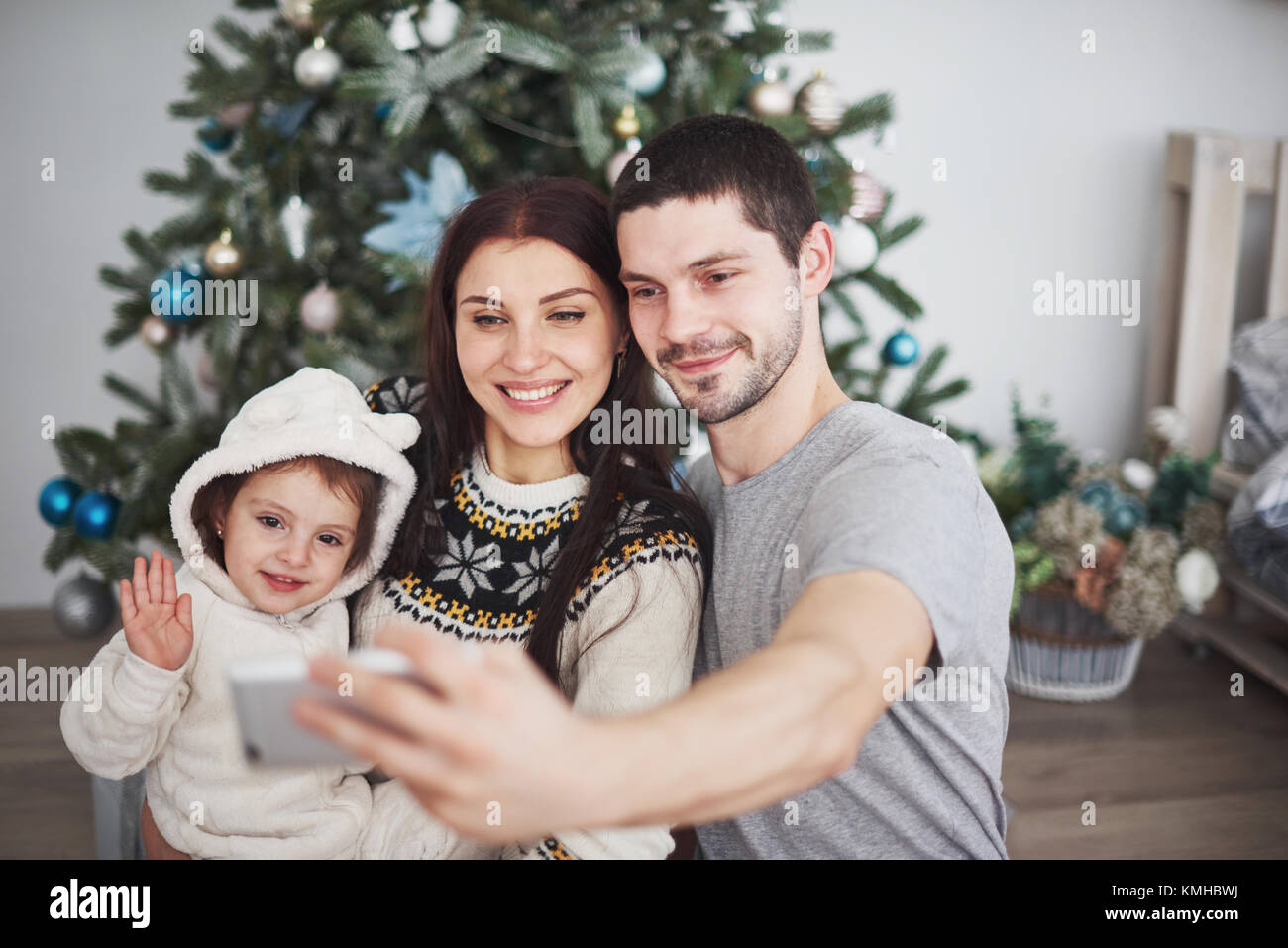 Family gathered around christmas tree hi-res stock photography and ...