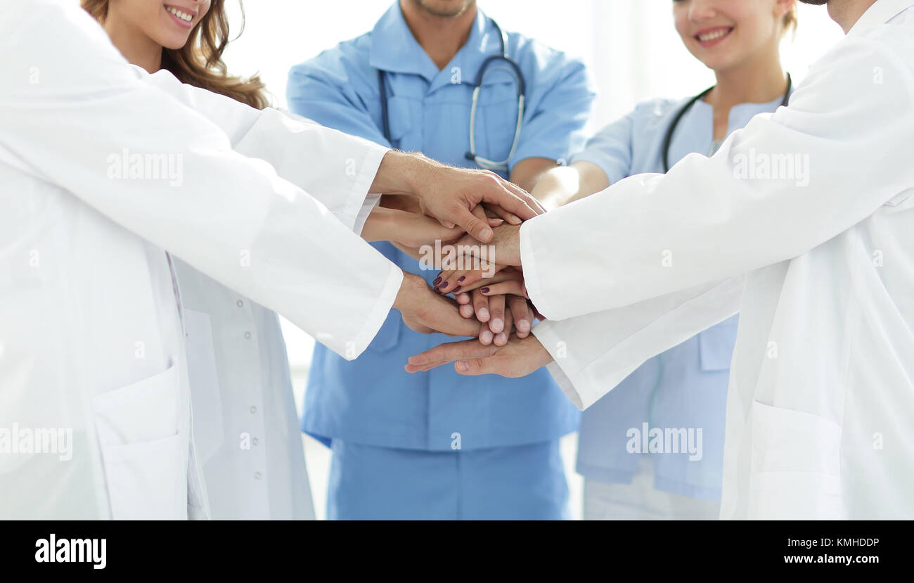 Doctors and nurses stacking hands. concept of mutual aid Stock Photo ...