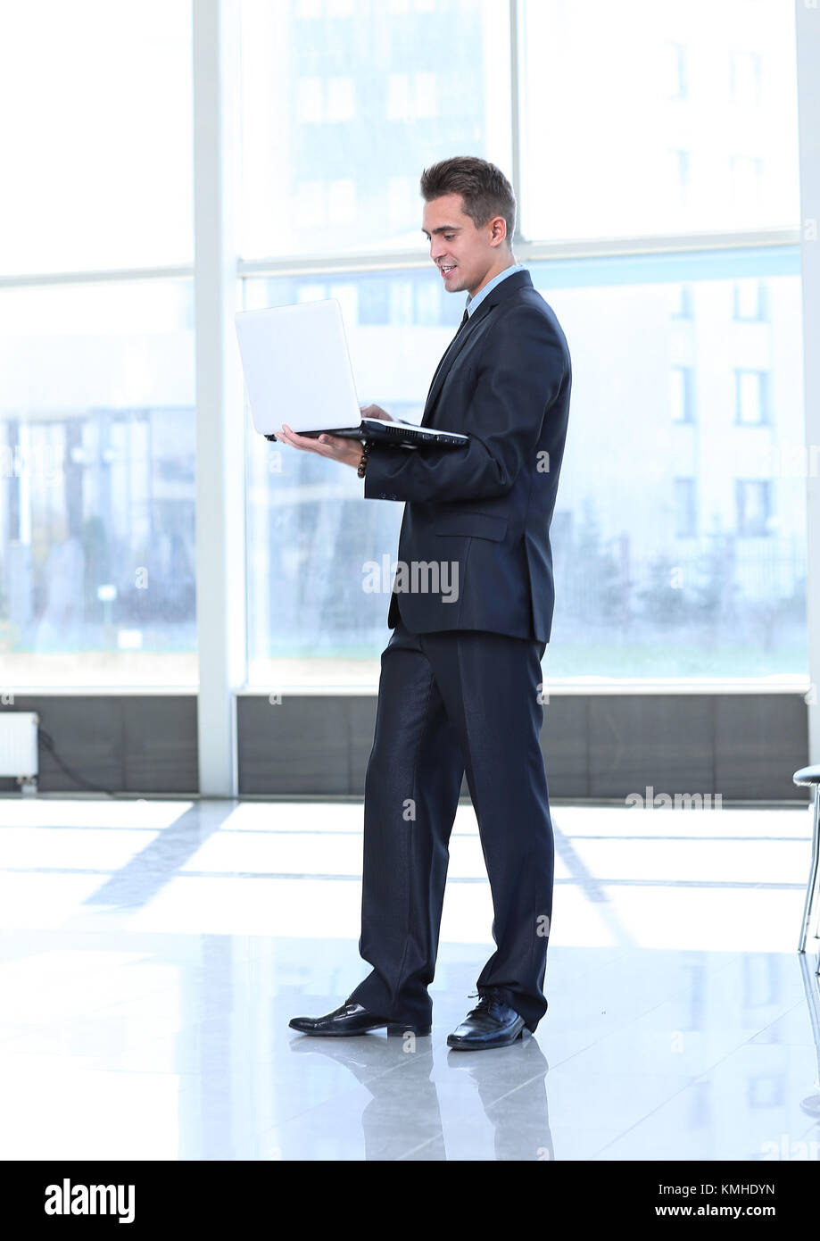 Male business executive using laptop in office Stock Photo - Alamy