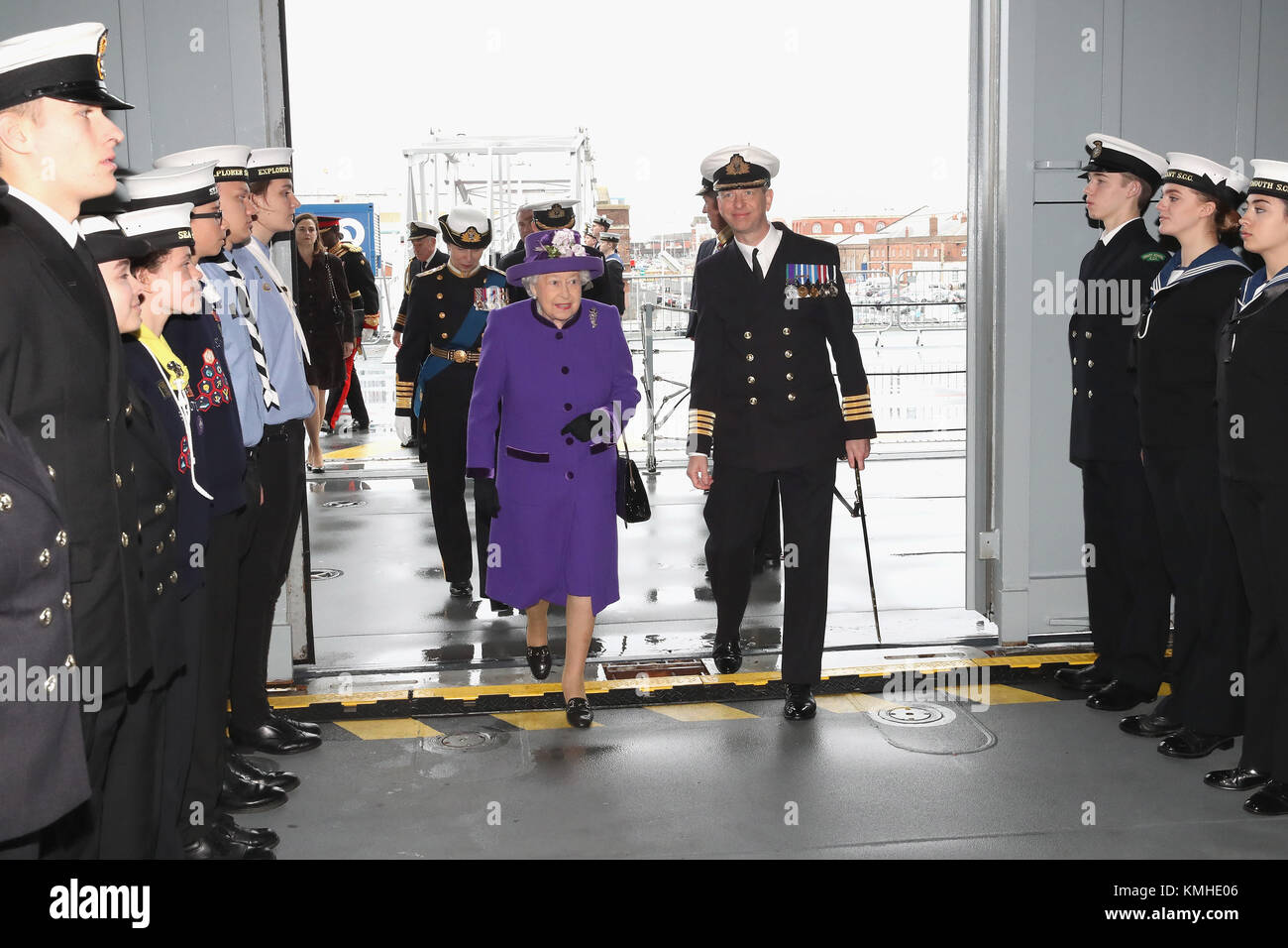 Queen Elizabeth II walks with the shipÕs Captain, Commodore Jerry Kyd ...