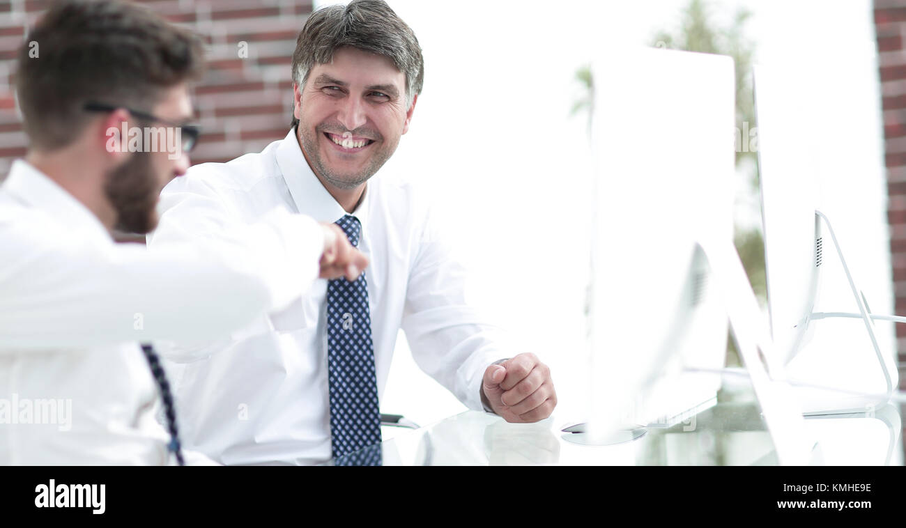 Smiling manager at his desk in the office Stock Photo - Alamy