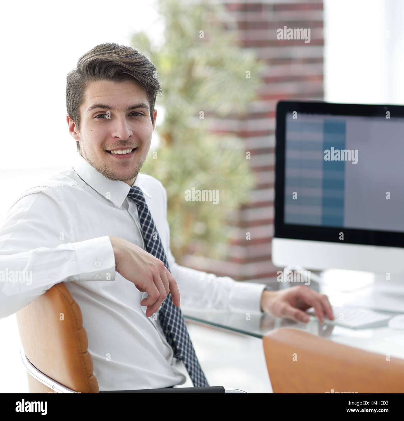 employee sitting in front of a computer screen Stock Photo - Alamy