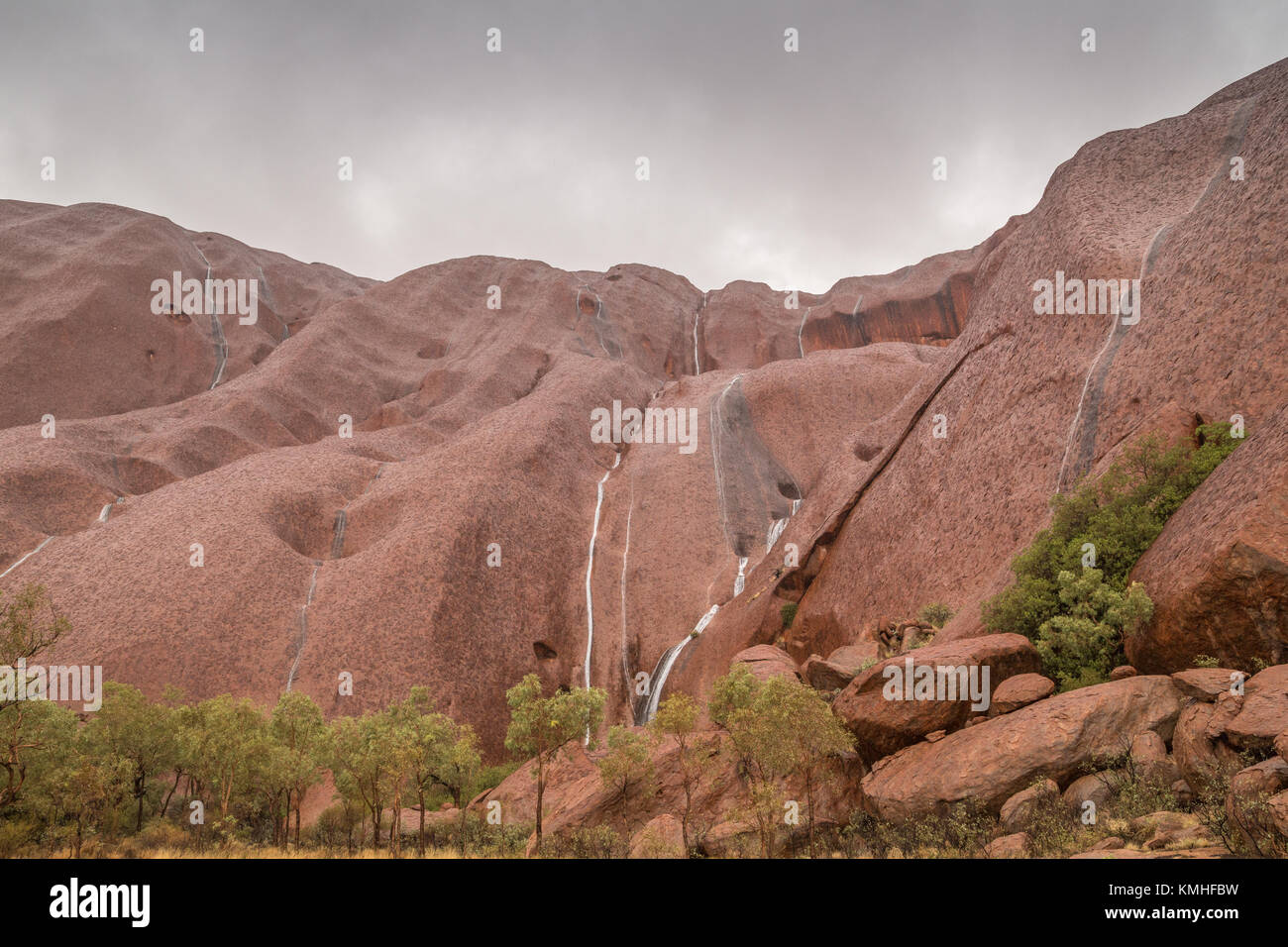 Ayers Rock in the rain - waterfalls on Uluru during a rare rainstorm in ...