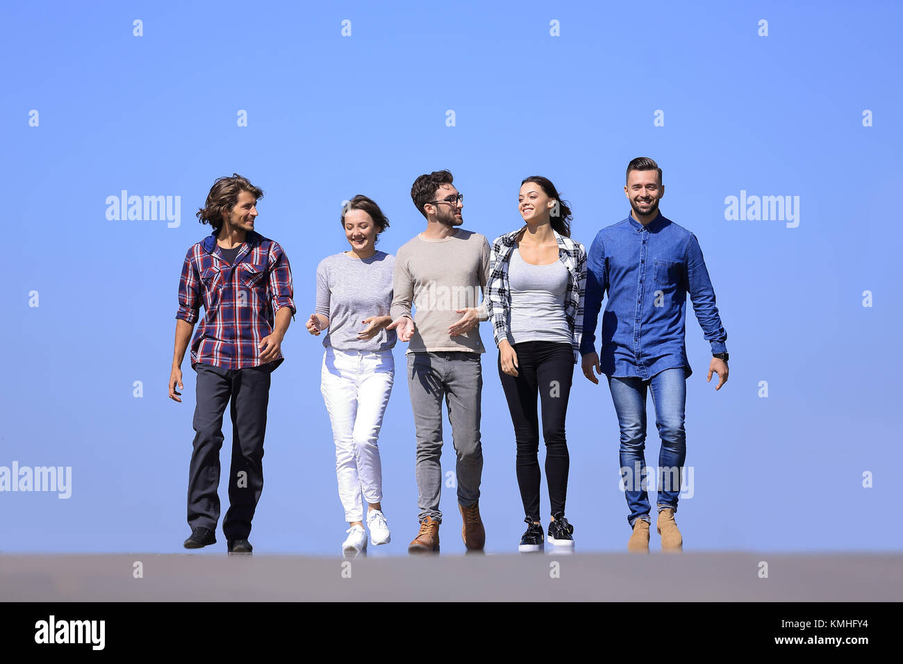 team of young people walking along the road.outdoors Stock Photo - Alamy