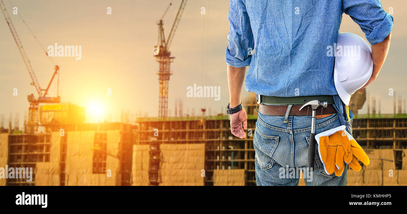 construction worker checking location site with crane on the background ...