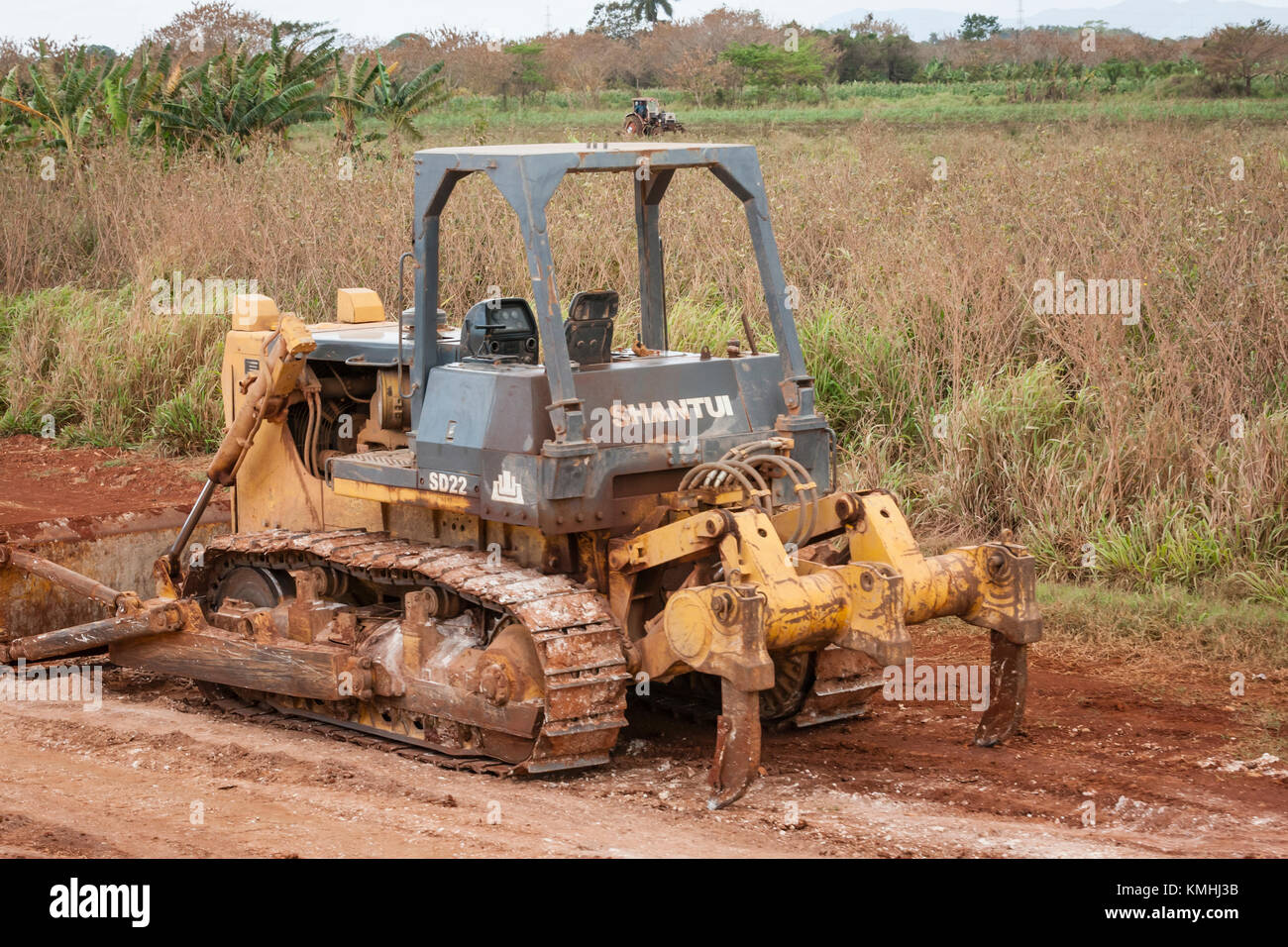 Rusty tractor in Cuban field Stock Photo - Alamy