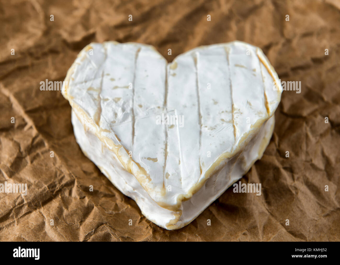 a French Neufchatel cheese shaped heart on paper Stock Photo - Alamy