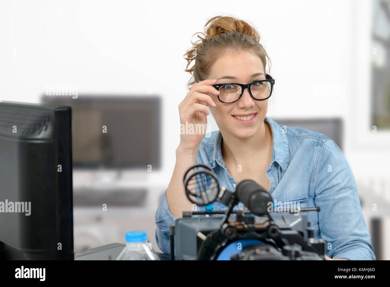 smiling young woman video editing in office Stock Photo - Alamy