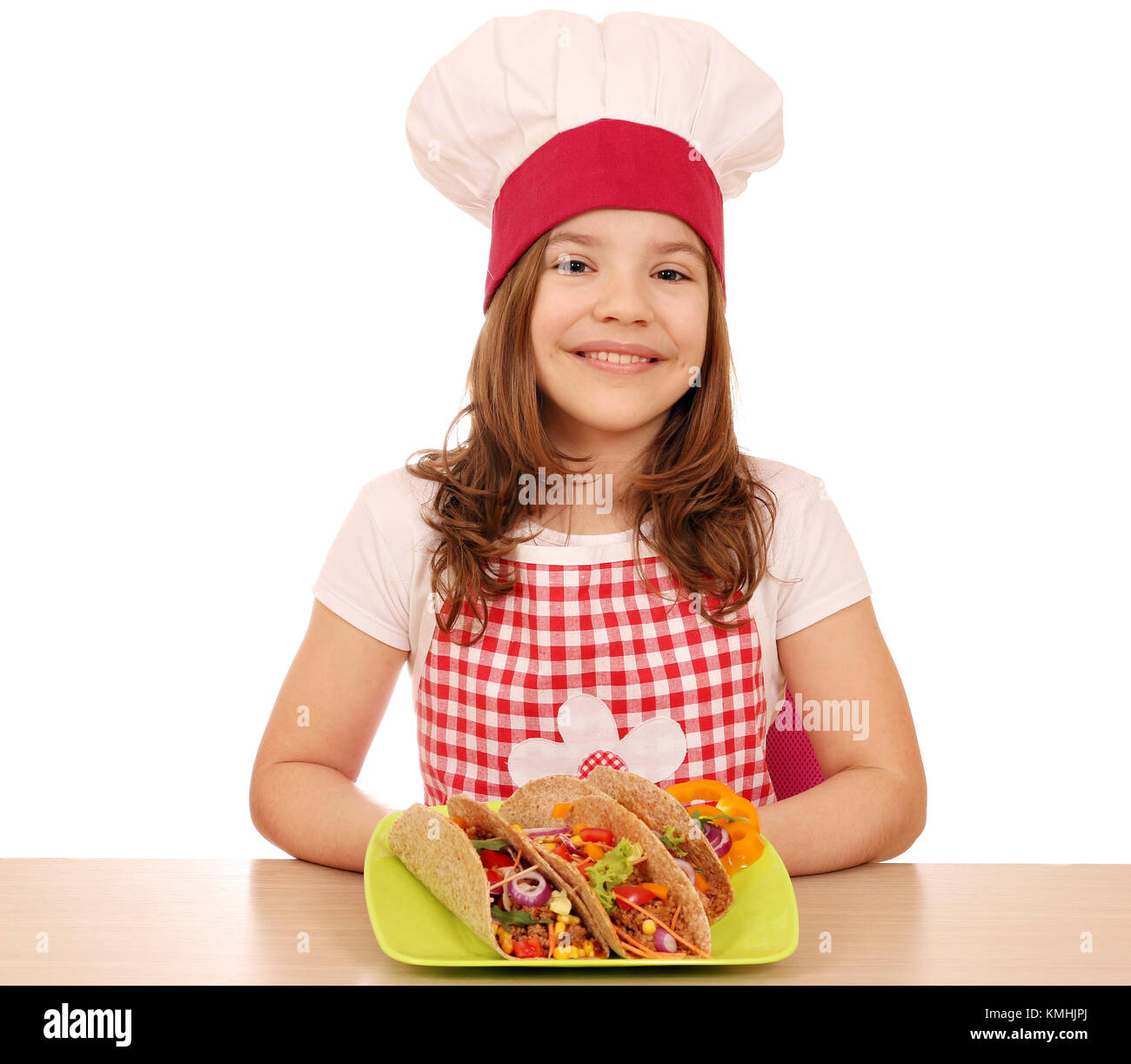 Happy little girl cook with tacos on table Stock Photo - Alamy