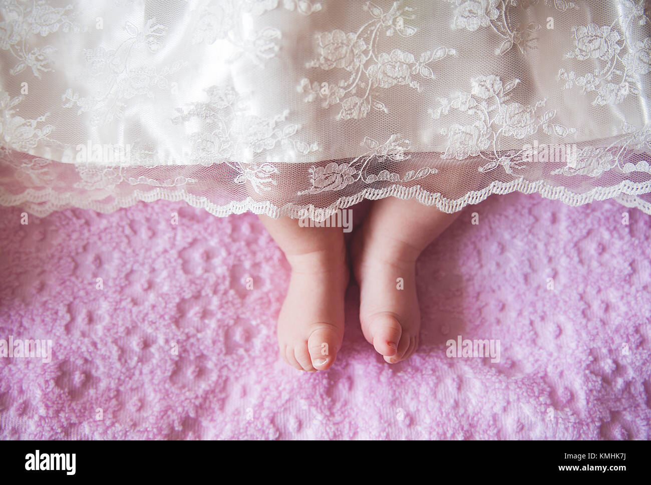 little girls legs under white lace cloth Stock Photo - Alamy