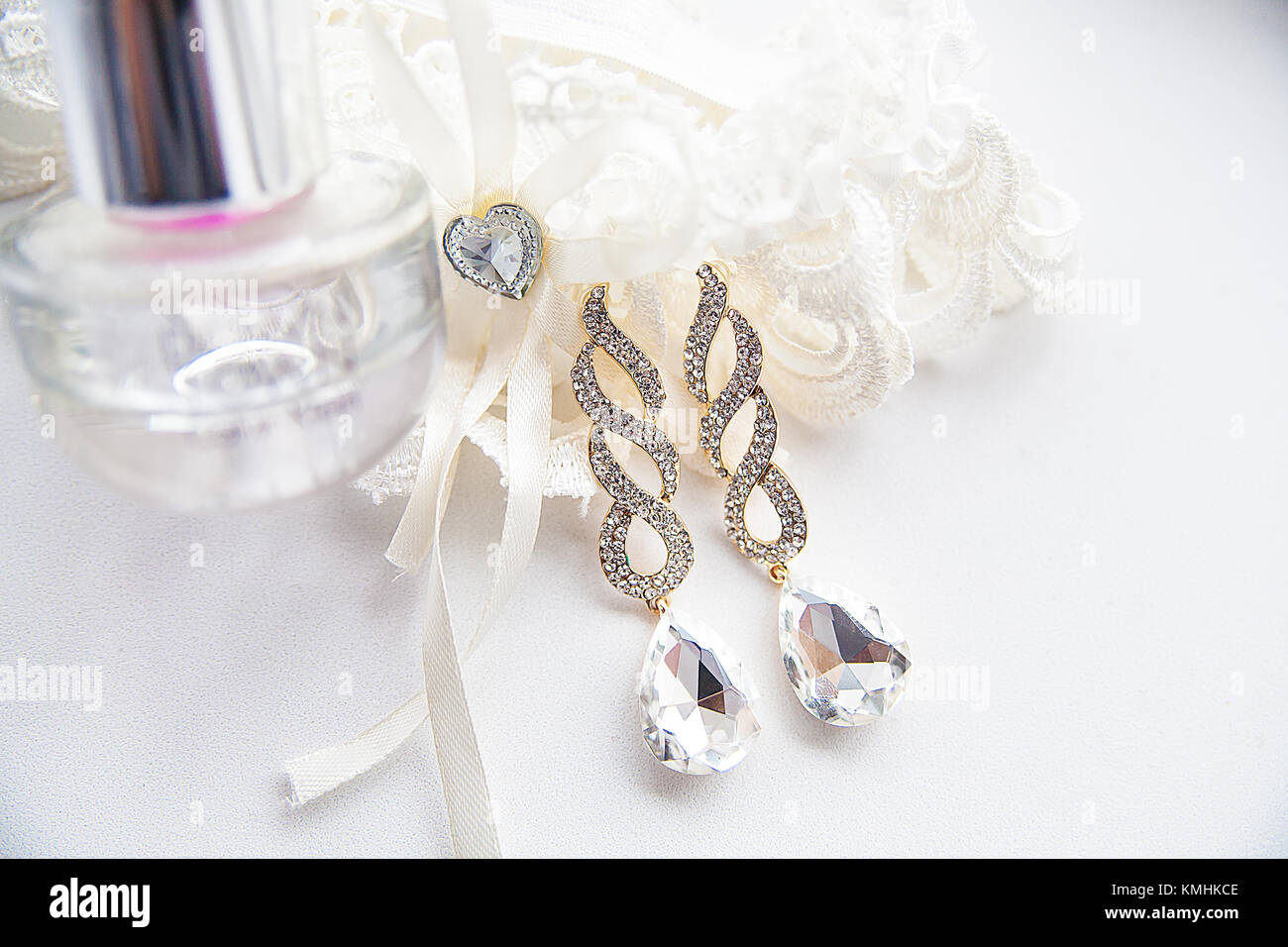 Beautiful set of wedding accessories, perfume and earrings Stock Photo ...