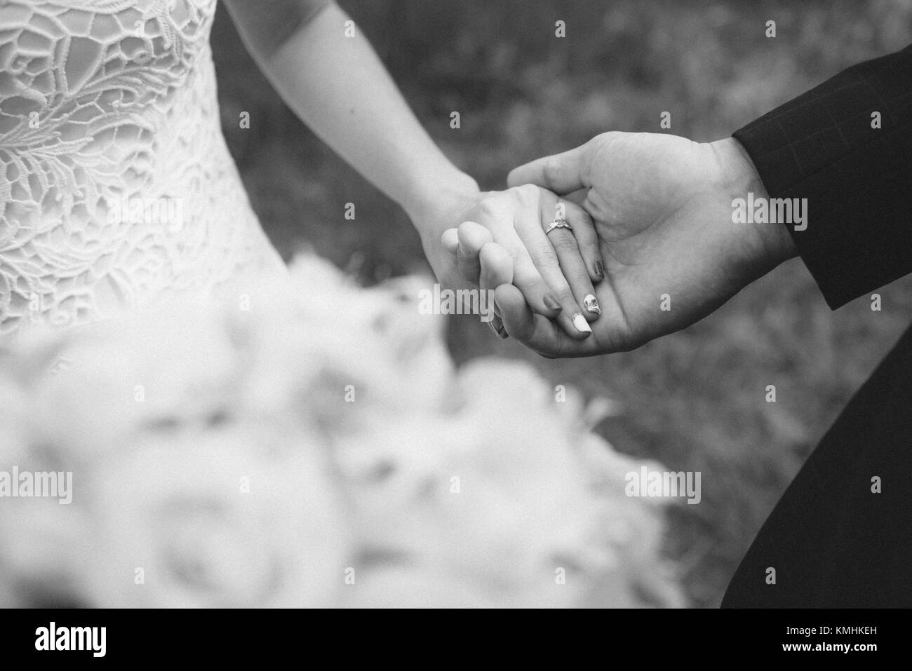Young married couple holding hands, ceremony wedding day Stock Photo ...