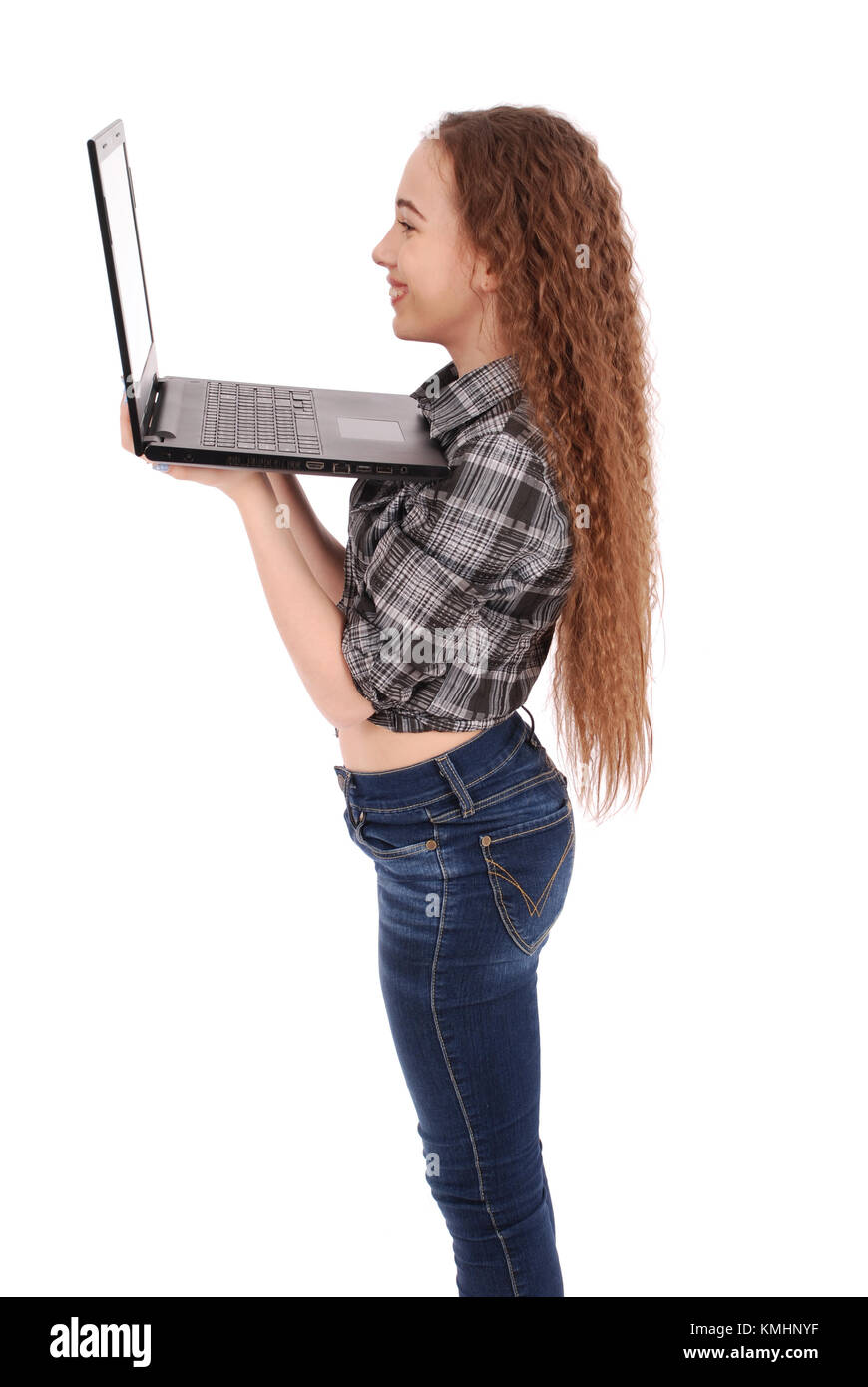 Young girl standing and using a laptop, isolated on white Stock Photo ...