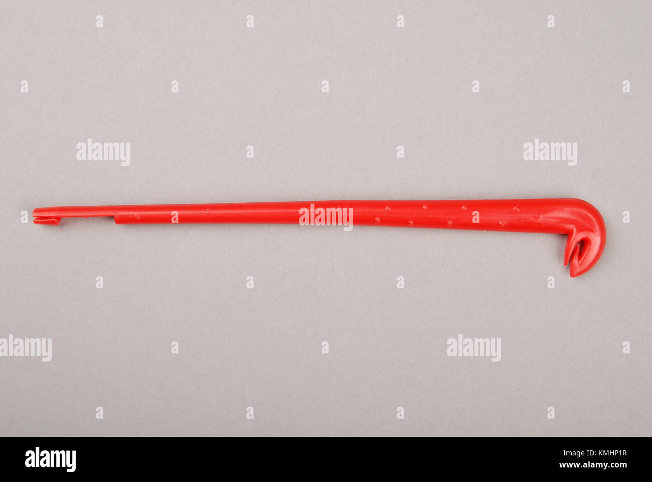 One red loop tier isolated on gray background Stock Photo - Alamy