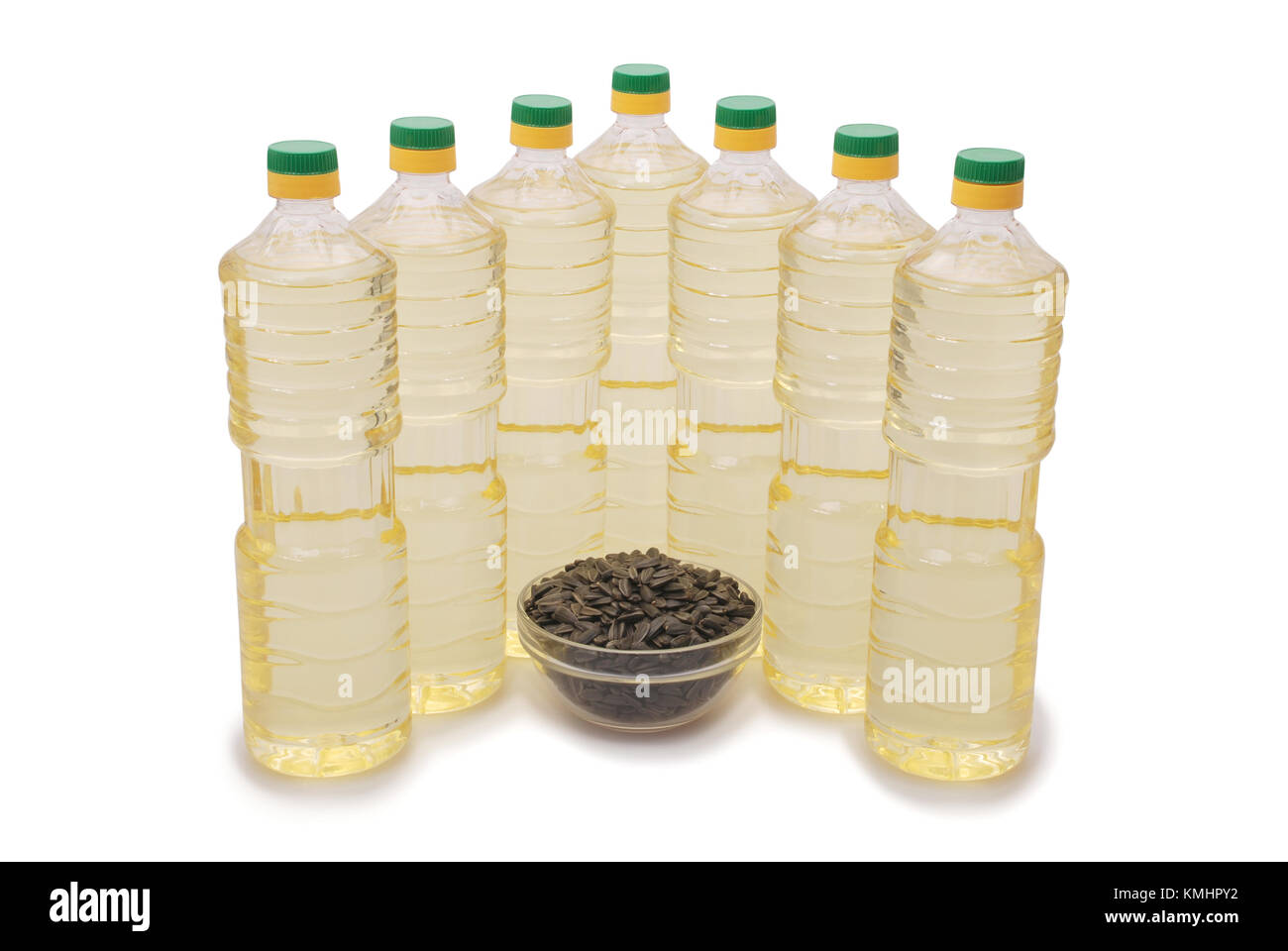 Bottle of sunflower oil and the bowl is full of grain oil isolated on ...