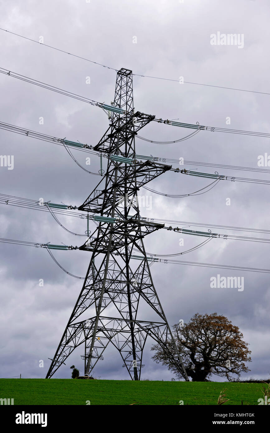 Overhead electricity cables and large pylons across open countryside ...