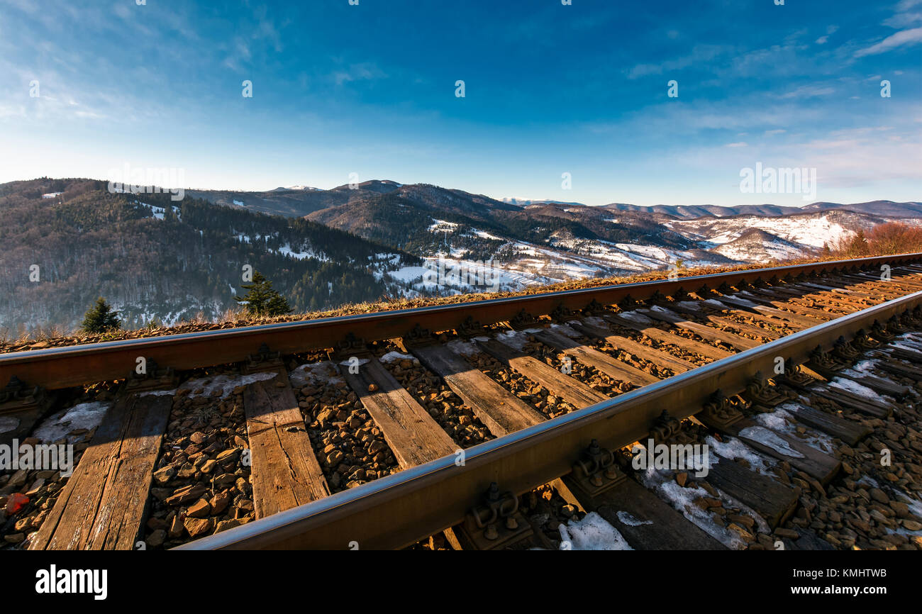 railroad in mountains with snowy slopes. lovely transportation scenery ...