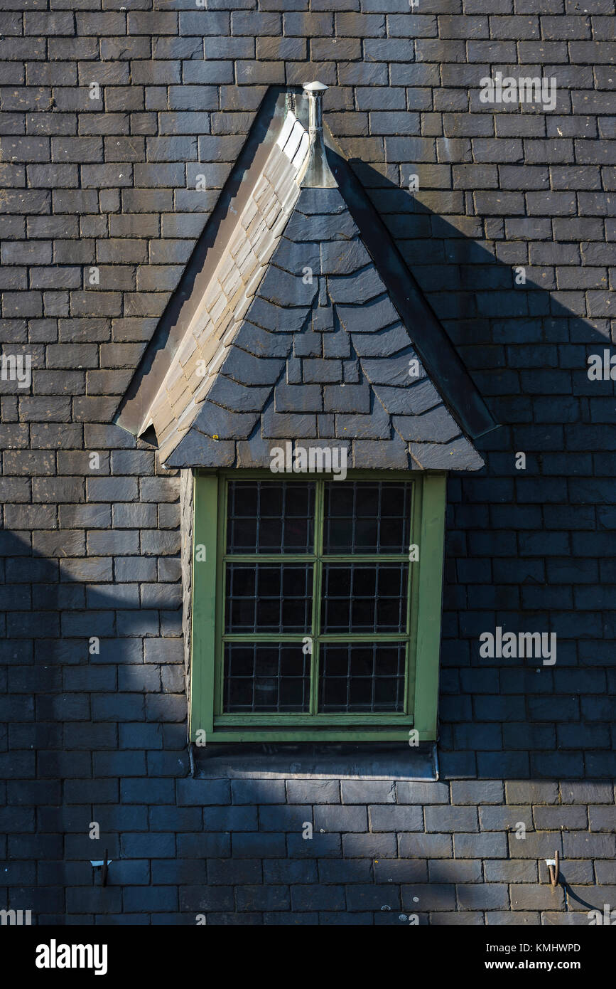 Window on the roof of an old medieval house in the old town of the ...
