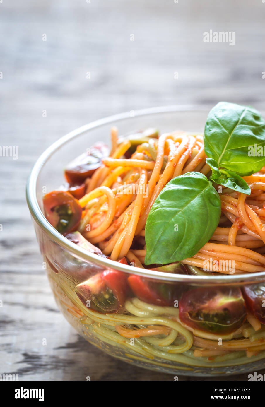Bowl of colorful spaghetti with cherry tomatoes Stock Photo - Alamy