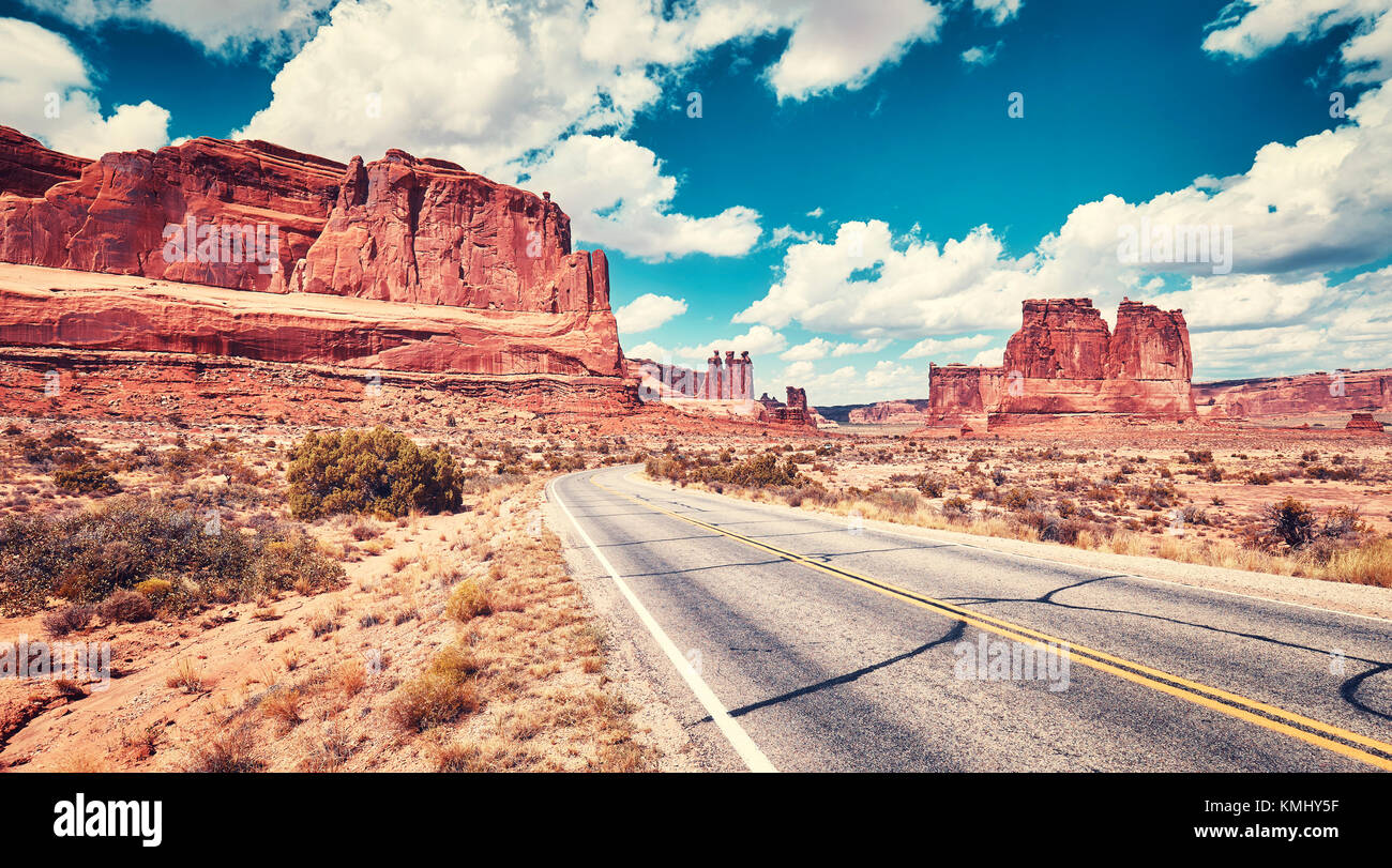 Vintage toned panoramic picture of a scenic road, travel concept ...