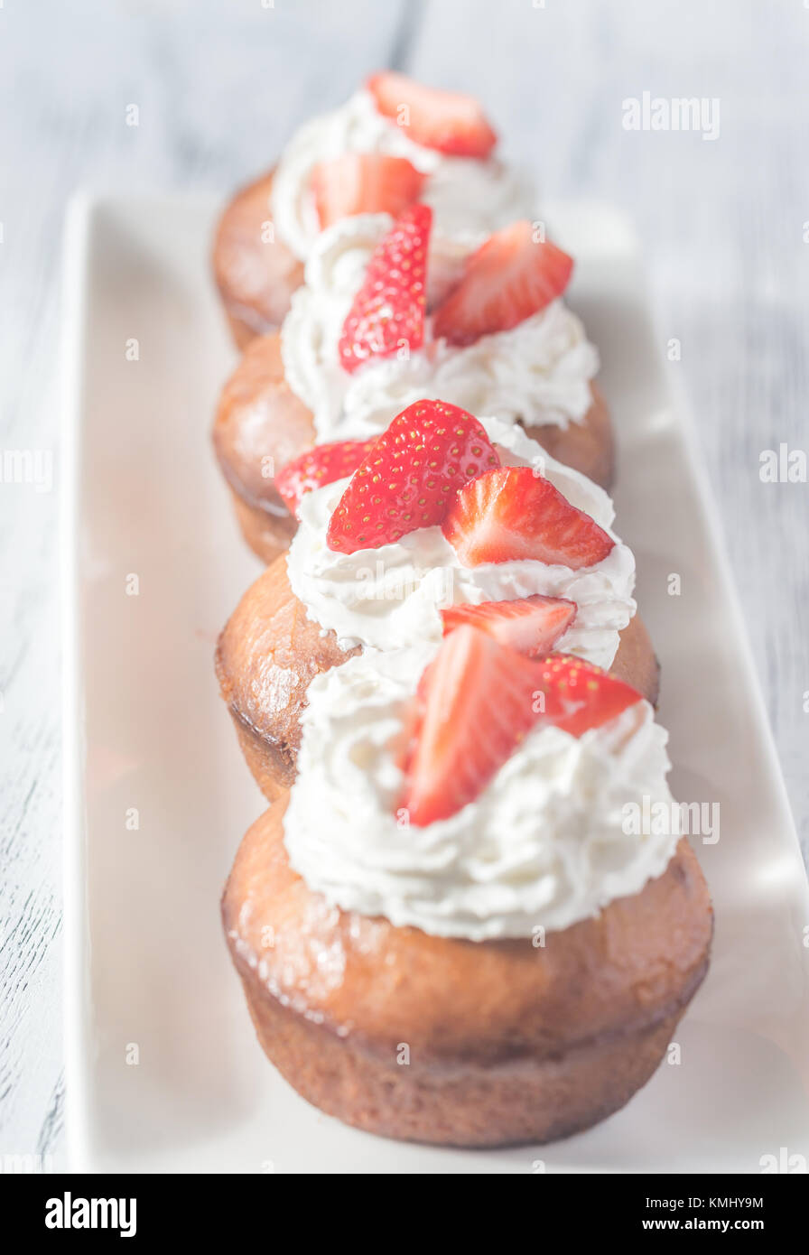 Rum baba on the plate arranged in a row Stock Photo - Alamy