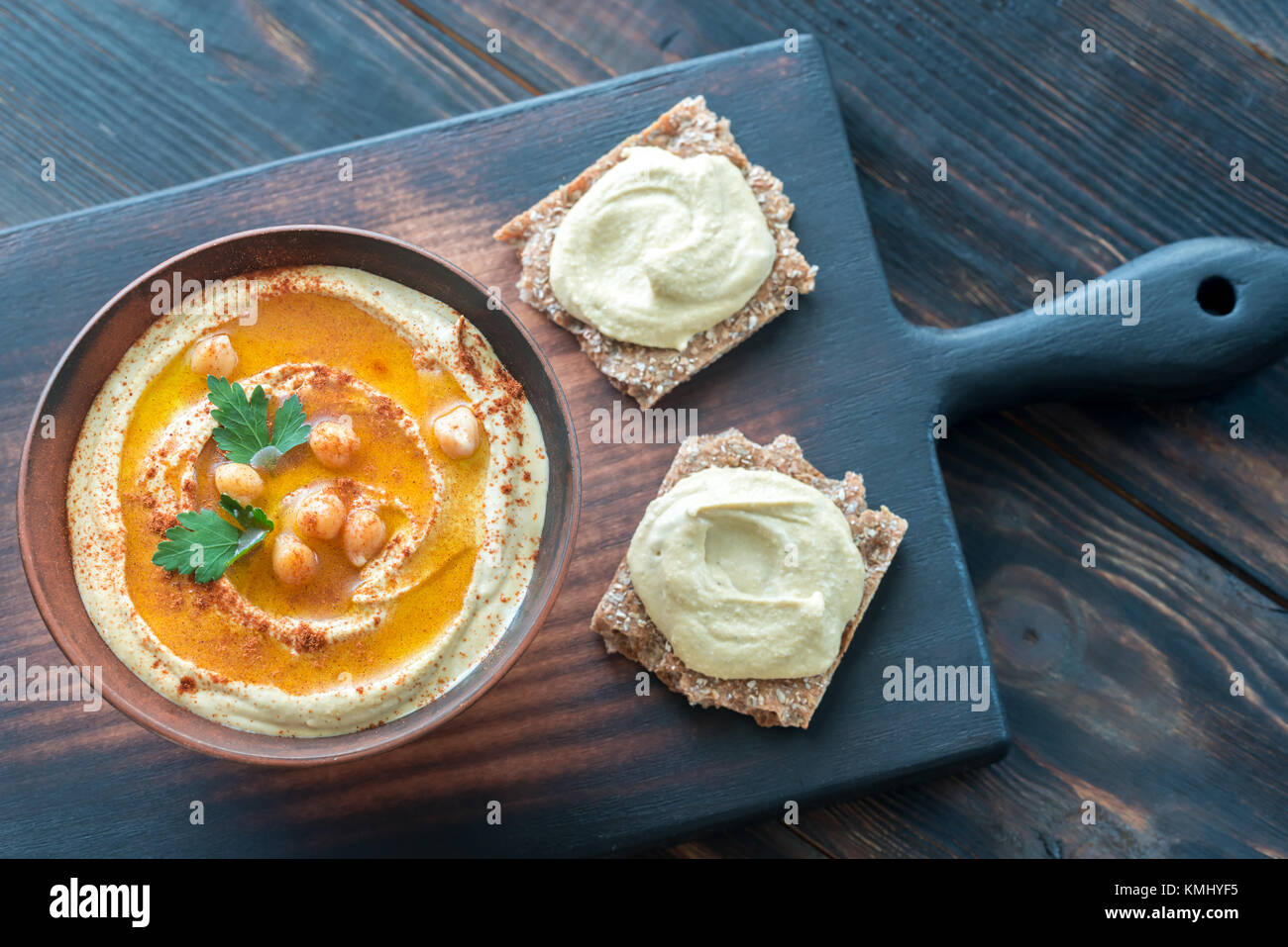 Bowl of hummus on the wooden table Stock Photo - Alamy