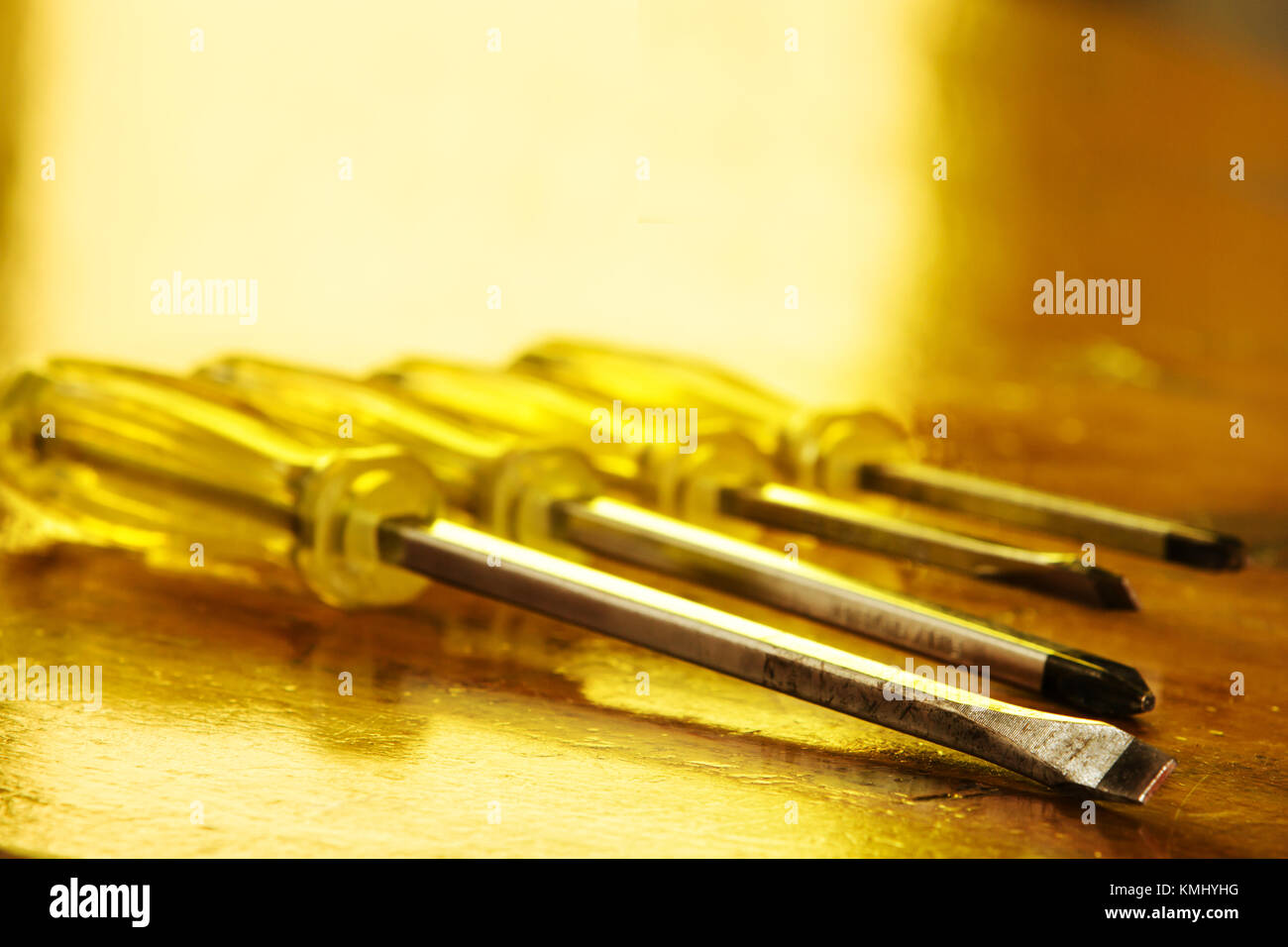 Horizontal photo of a yellow screwdrivers set on a wood table Stock ...