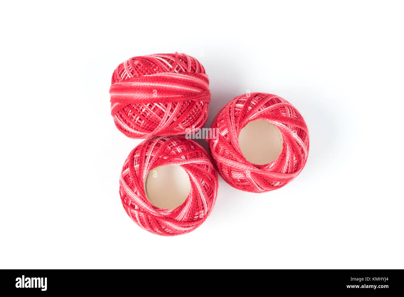 Three red sewing threads on a white background Stock Photo - Alamy