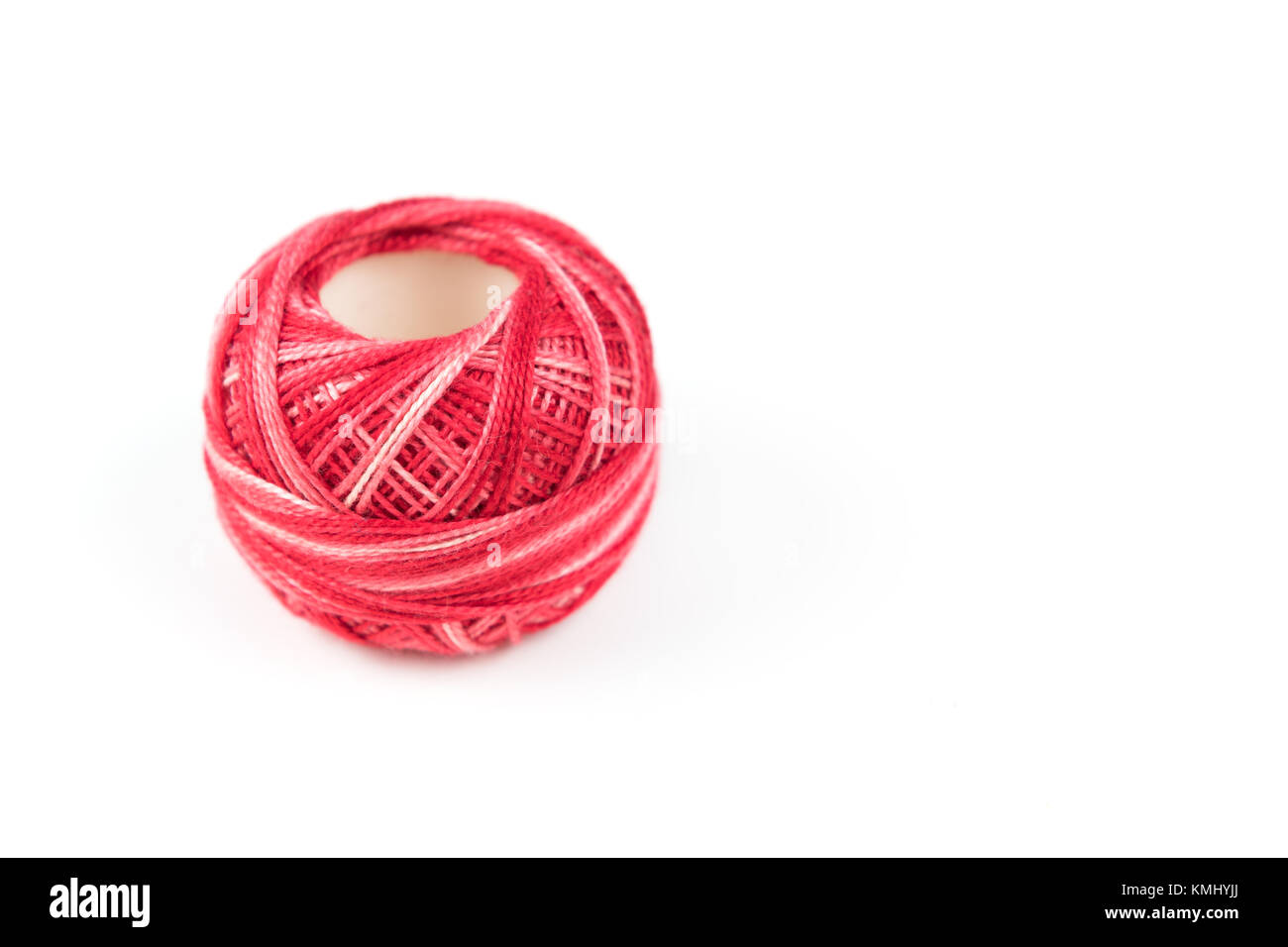 Red sewing thread on a white background Stock Photo - Alamy