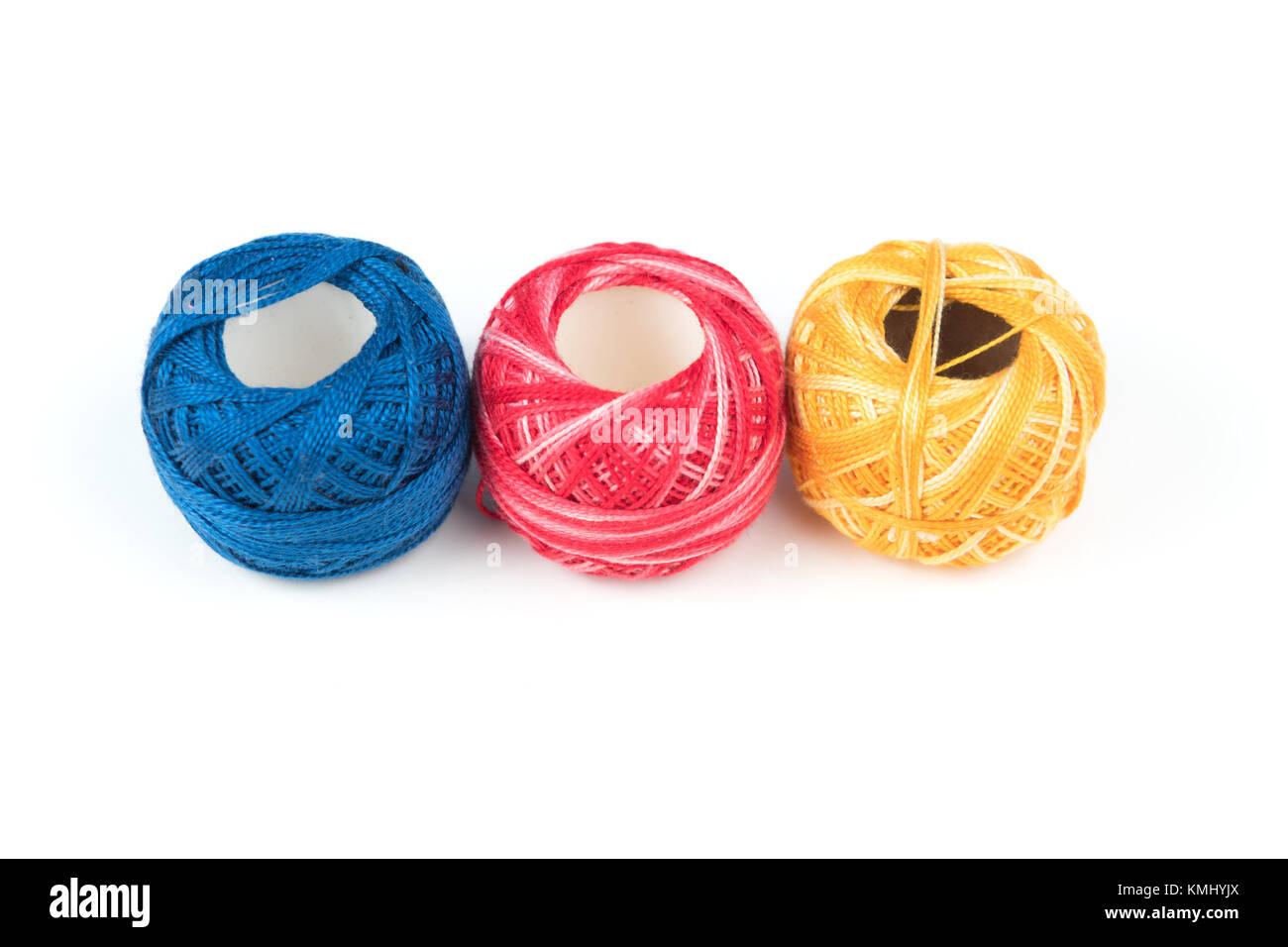 Three colored sewing threads on a white background, yellow, blue and red thread Stock Photo - Alamy