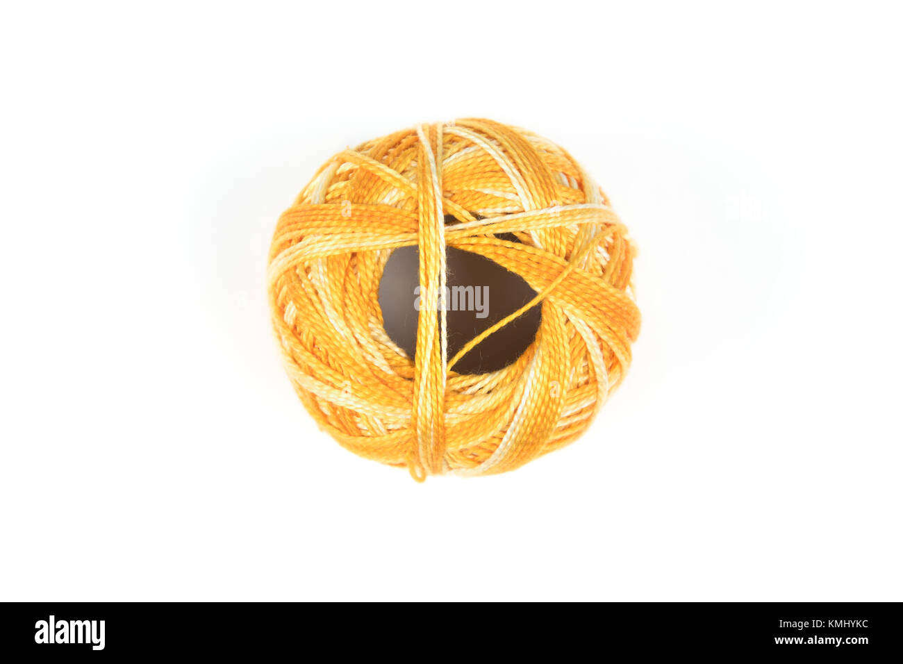 Single yellow sewing thread on a white background Stock Photo - Alamy