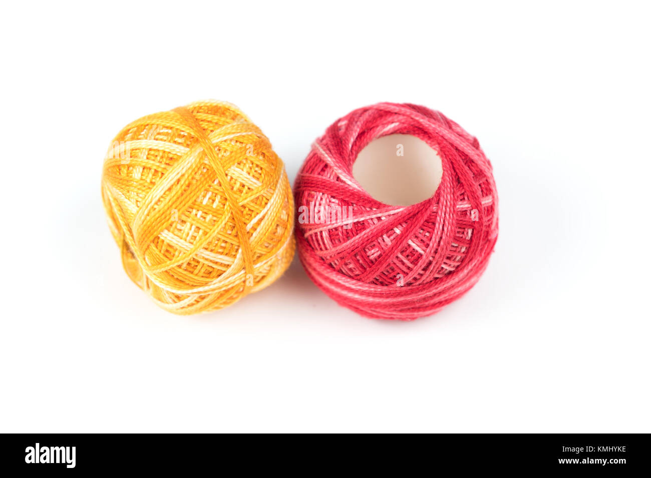 Yellow and red sewing threads on a white background Stock Photo - Alamy