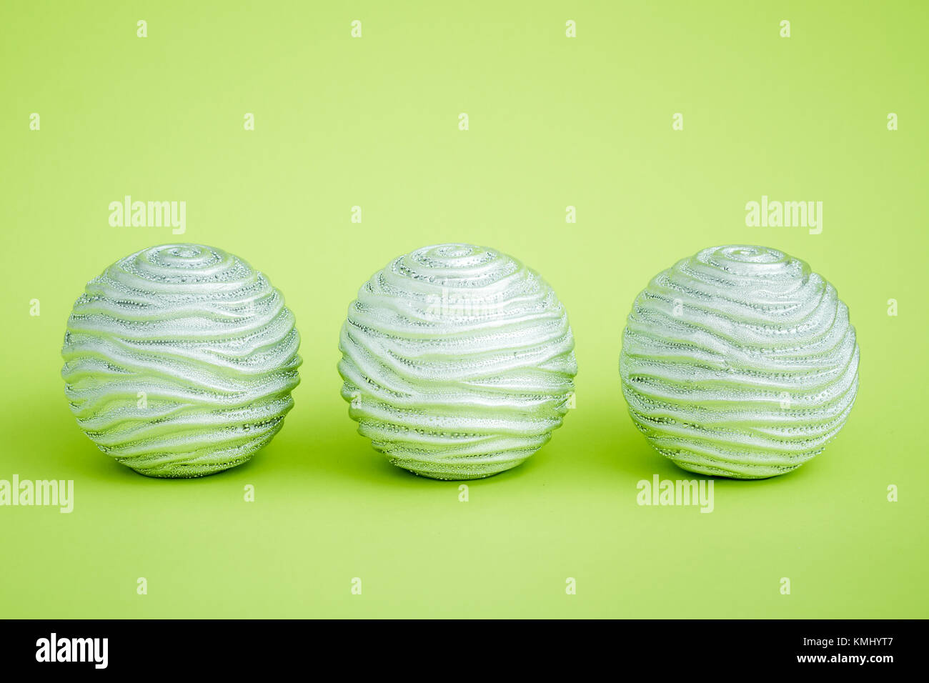 Decorative silver spheres on green background Stock Photo - Alamy