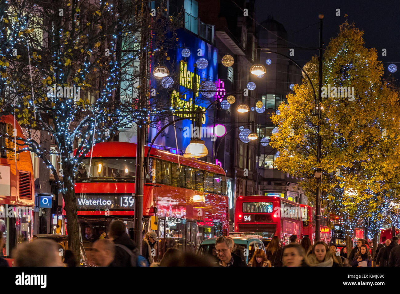 A line of London Buses moving along a busy Oxford St ,crowded with ...