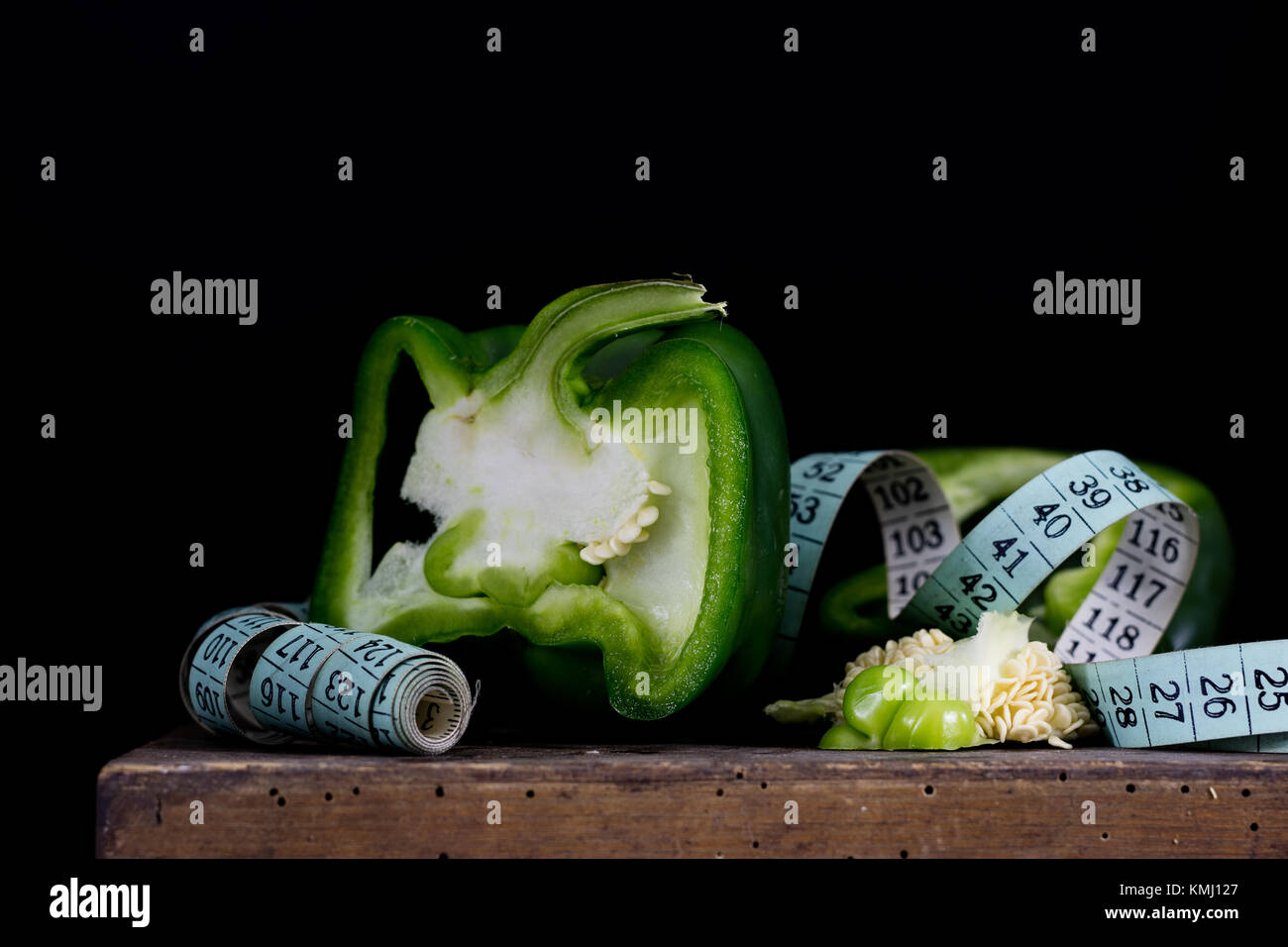 Cut out green peppers on old kitchen table and measure tailor ...