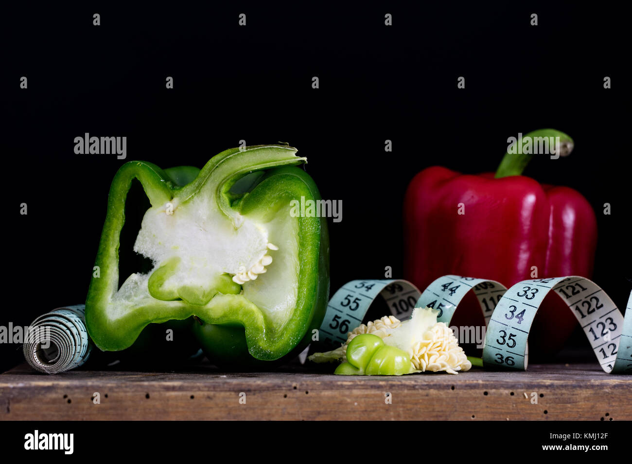 Cut out green peppers on old kitchen table and measure tailor ...