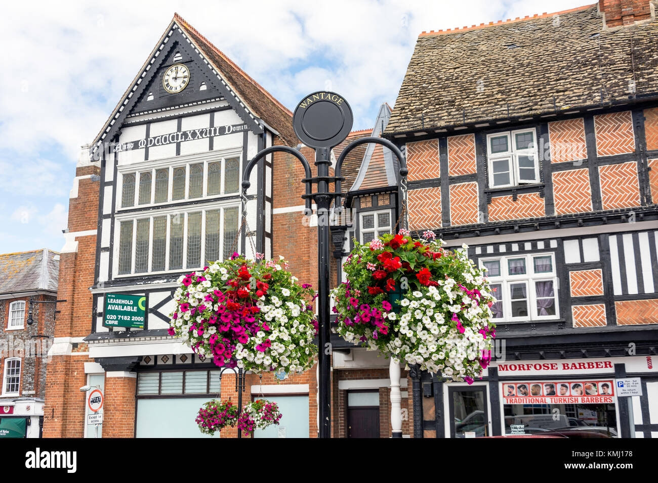 Period buildings and flower baskets, Market Place, Wantage, Oxfordshire ...
