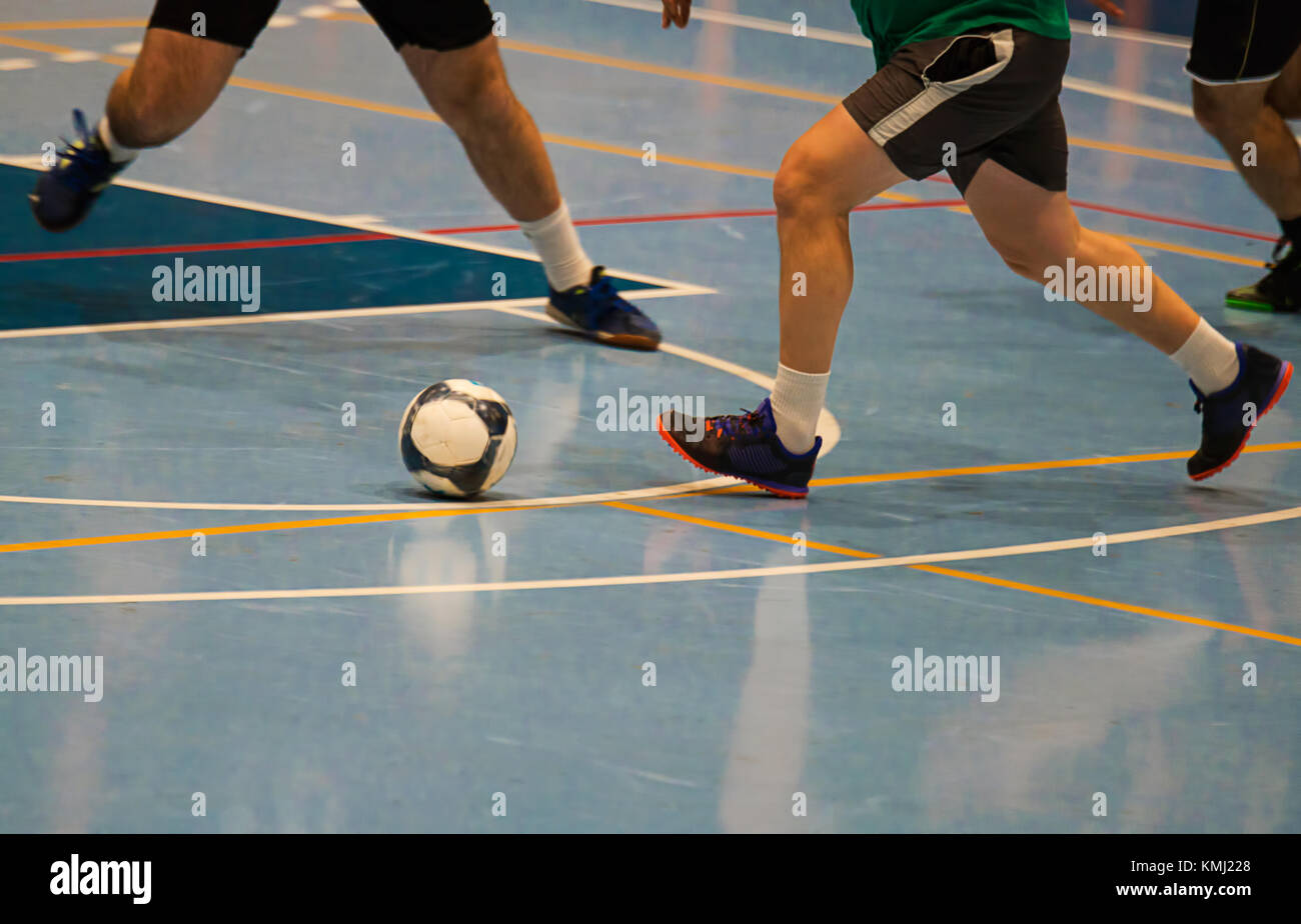 Futsal player with the ball in the sports hall Stock Photo - Alamy