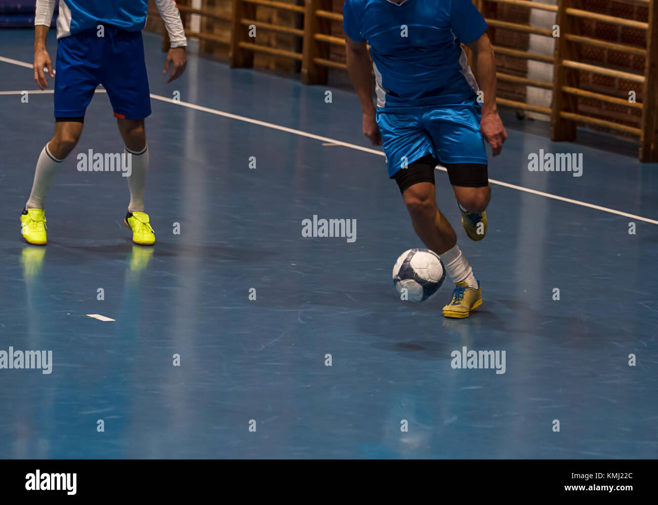 Futsal player with the ball in the sports hall Stock Photo - Alamy