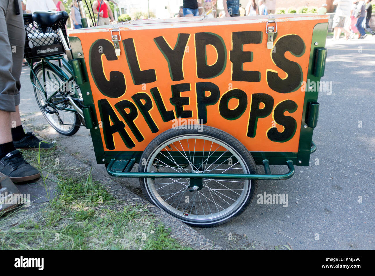 Great graphics "Clydes ApplePops" on the side of a street food pushcart ...
