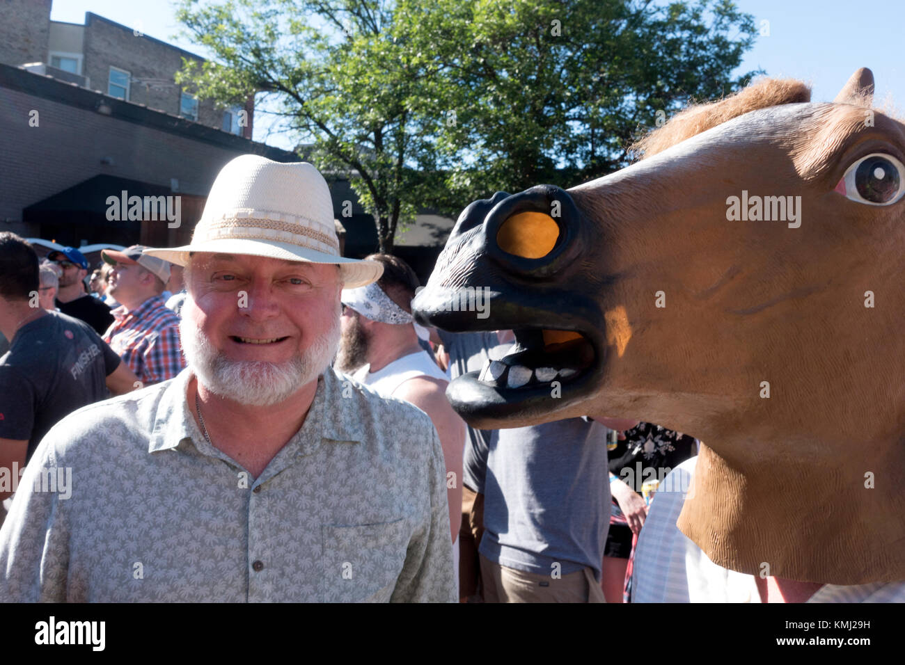Straw-hatted man and his horse friend attending a Grand Old Day ...