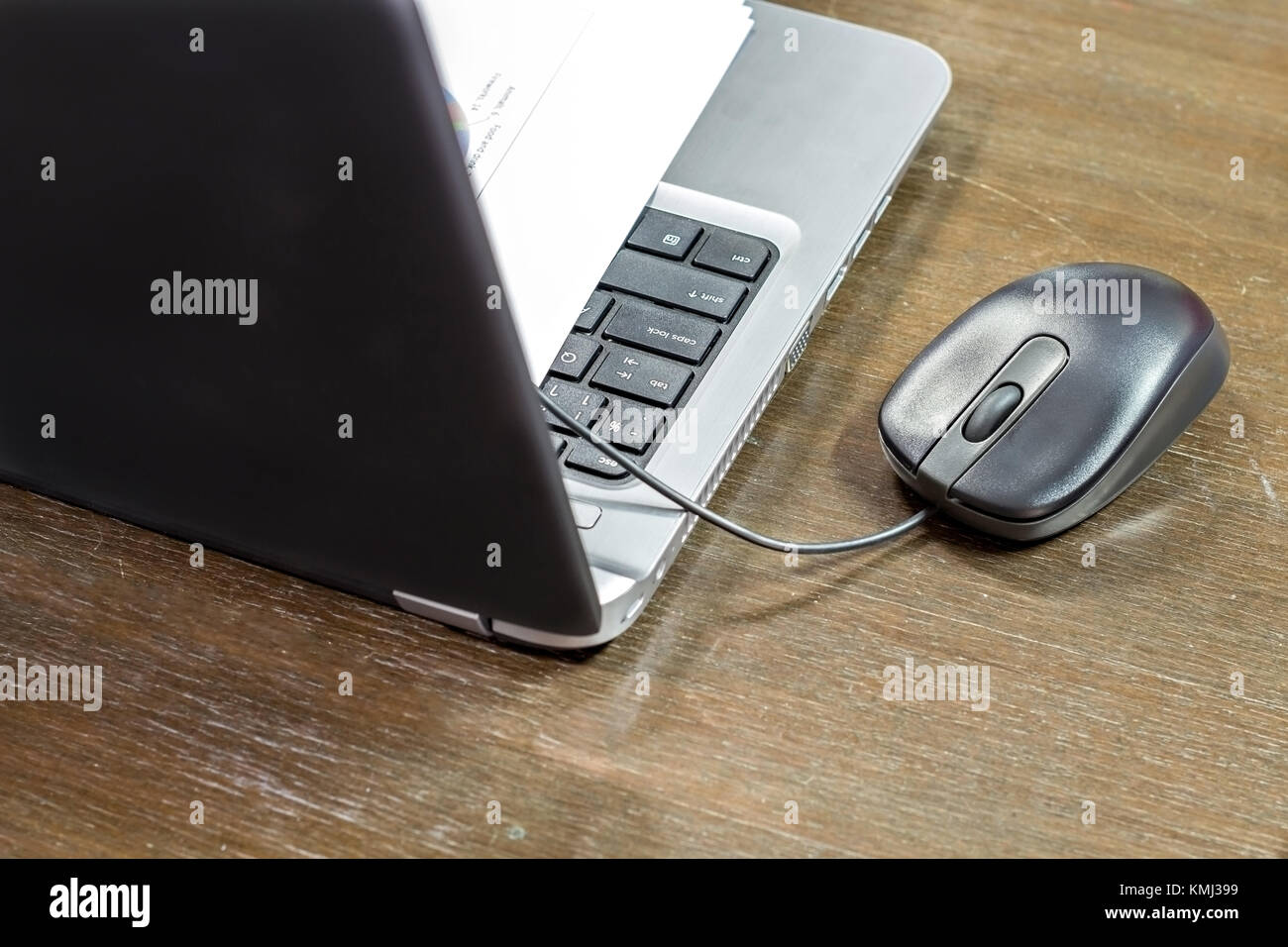 Laptop and mouse on vintage office wooden desk with selective focus ...