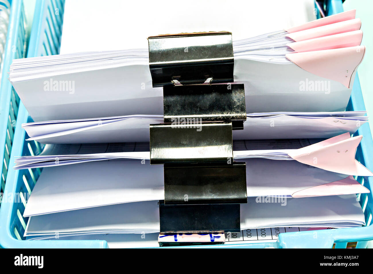 Documents with black paper clip in plastic basket Stock Photo - Alamy