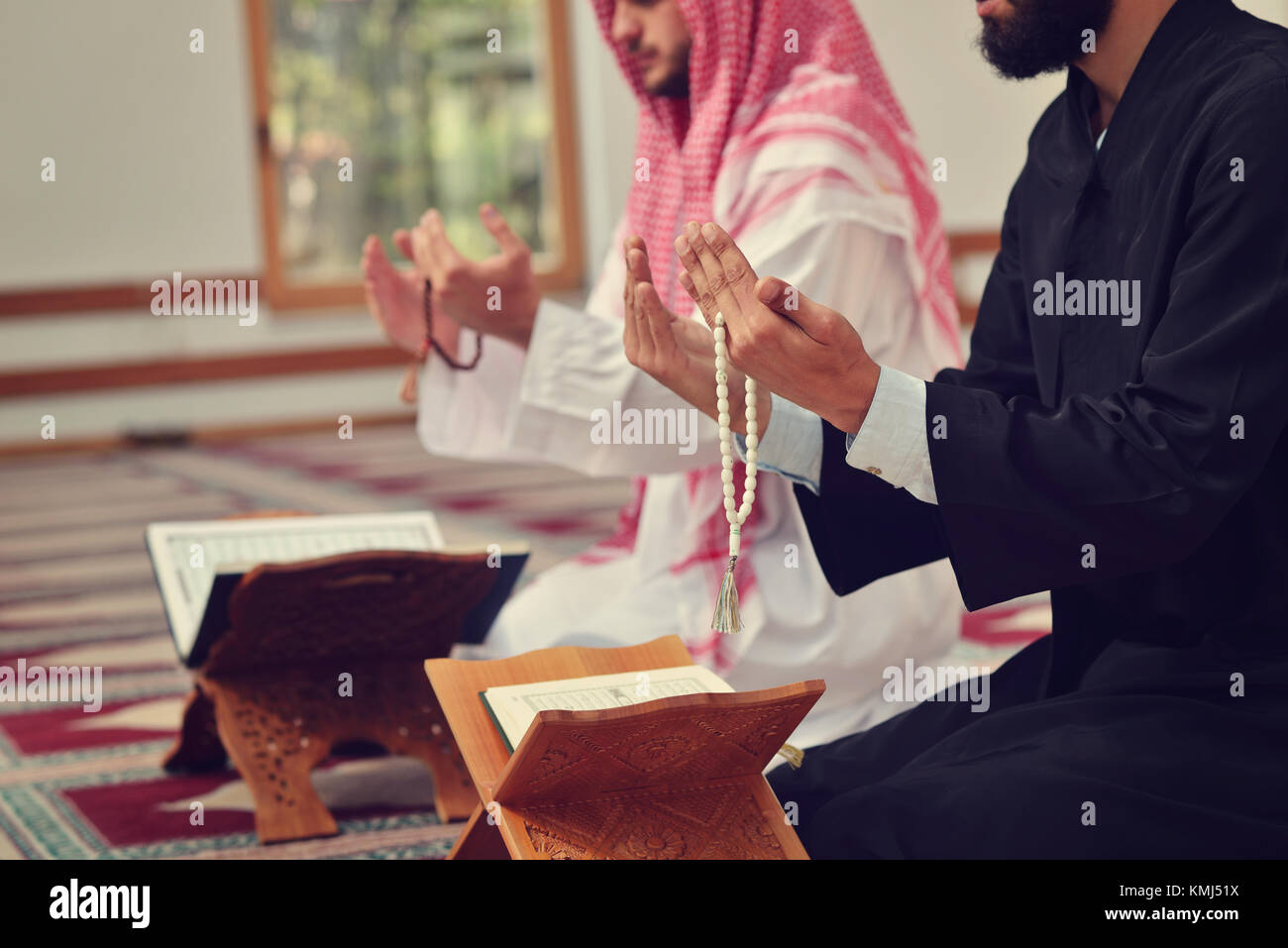 Two religious muslim man praying together inside the mosque Stock Photo ...