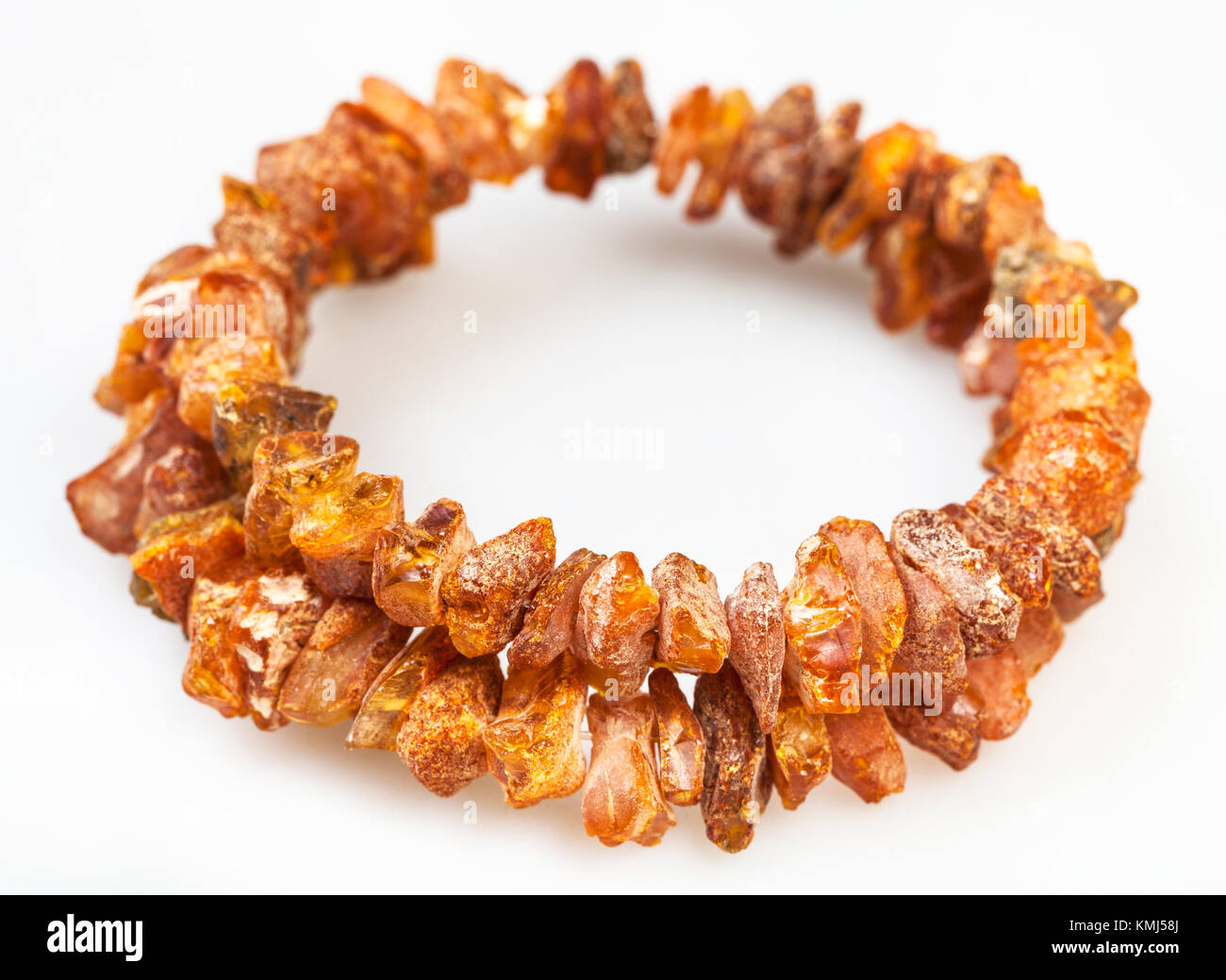 bracelet from two strings of wild amber stones on white concrete ...