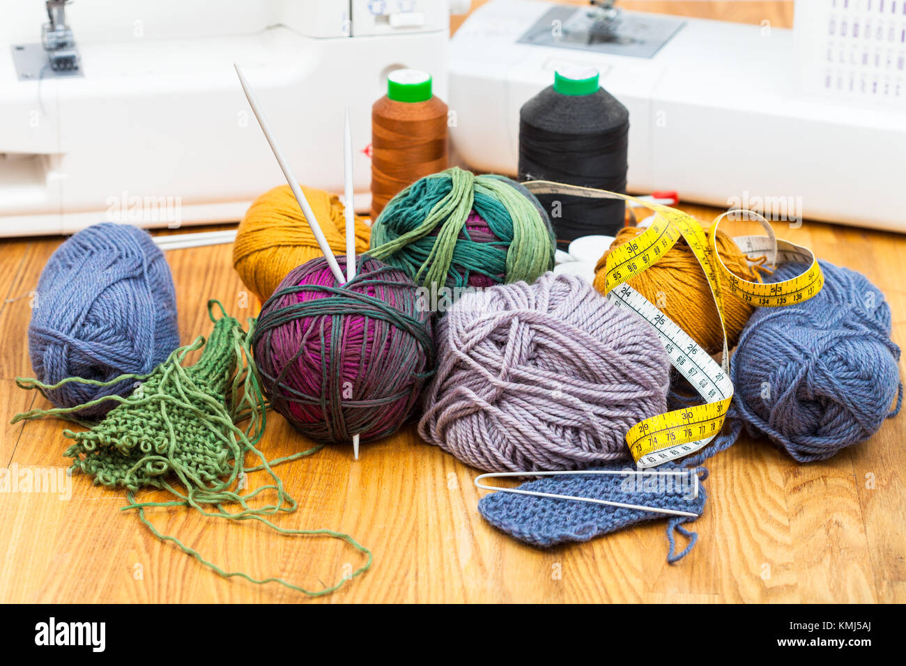 needlework still life - various knitting materials on table and sewing ...